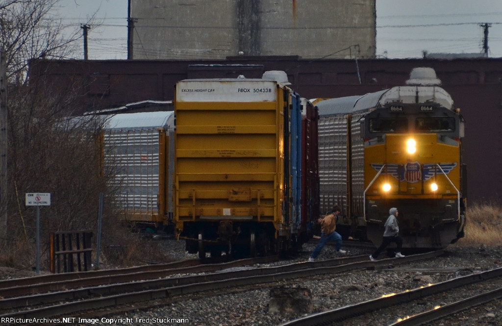 UP 8664 has it's lights on and bell ringing.